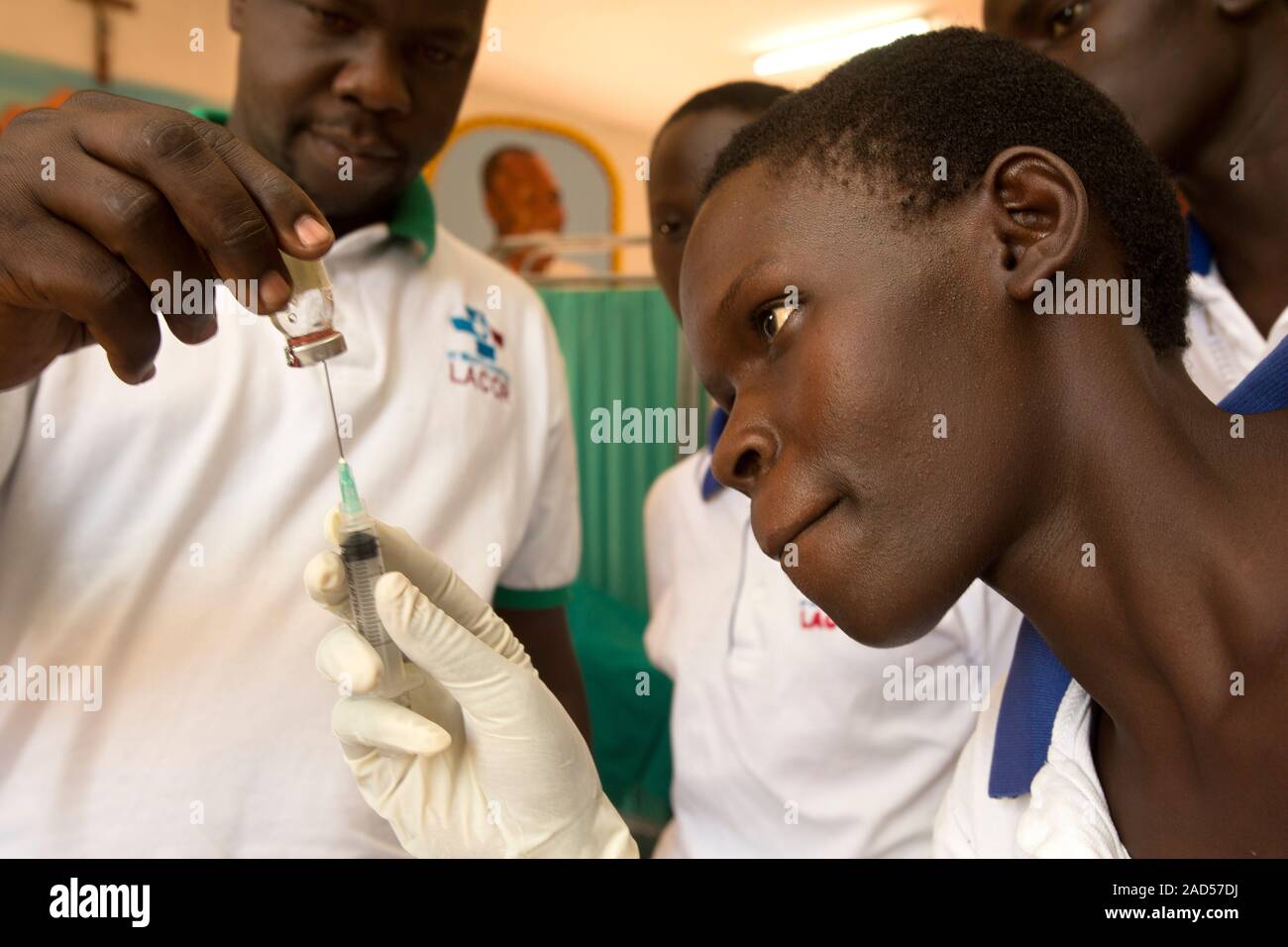 Injection techniques, hospital training. Student practising injection ...