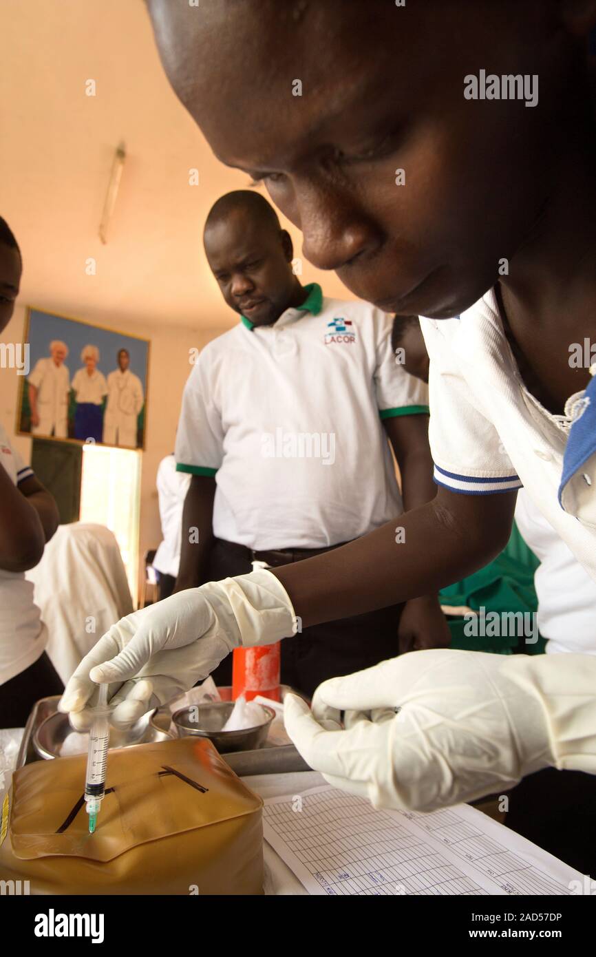 Injection techniques, hospital training. Student practising injection ...