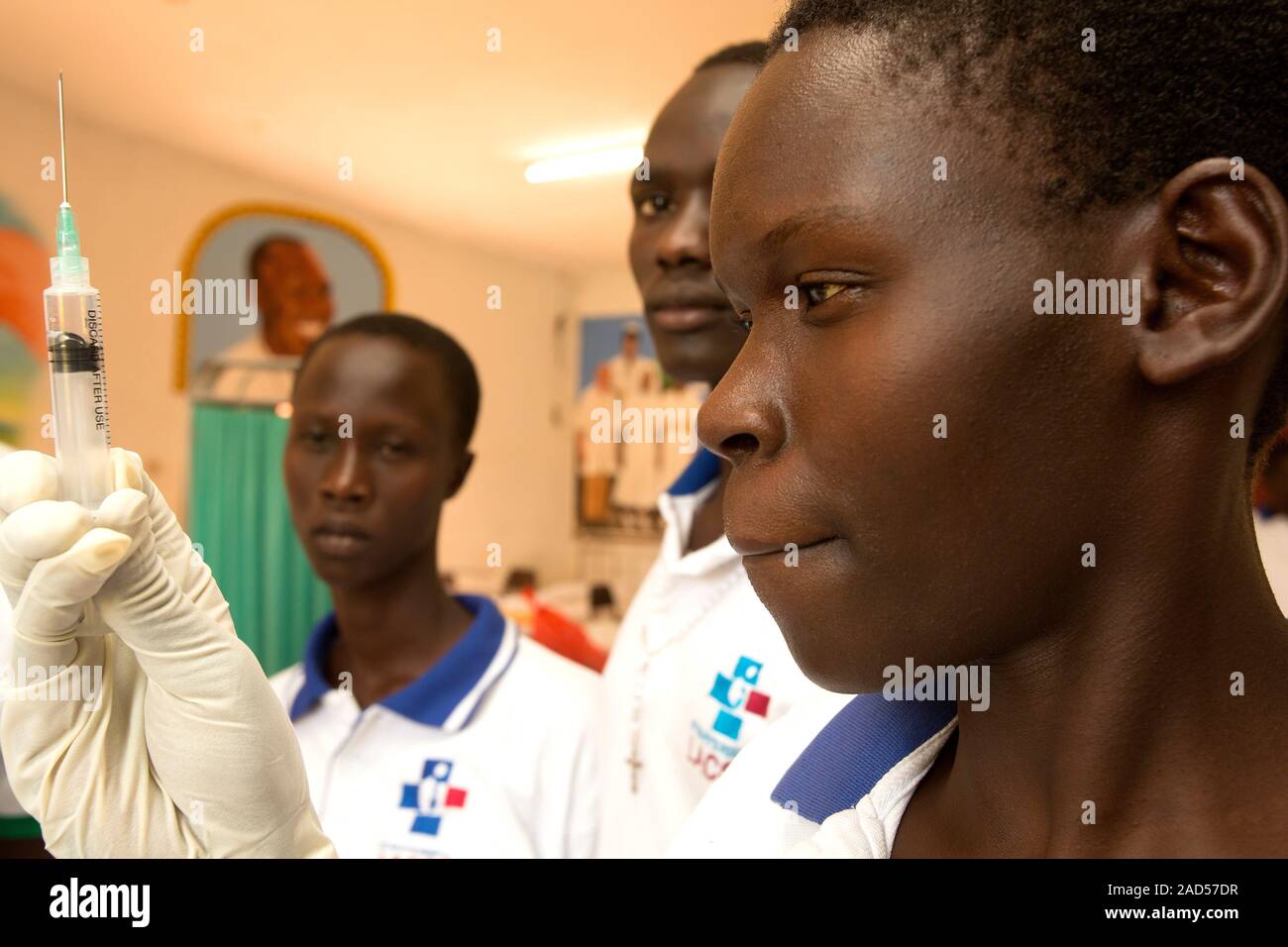 Injection techniques, hospital training. Student practising injection ...