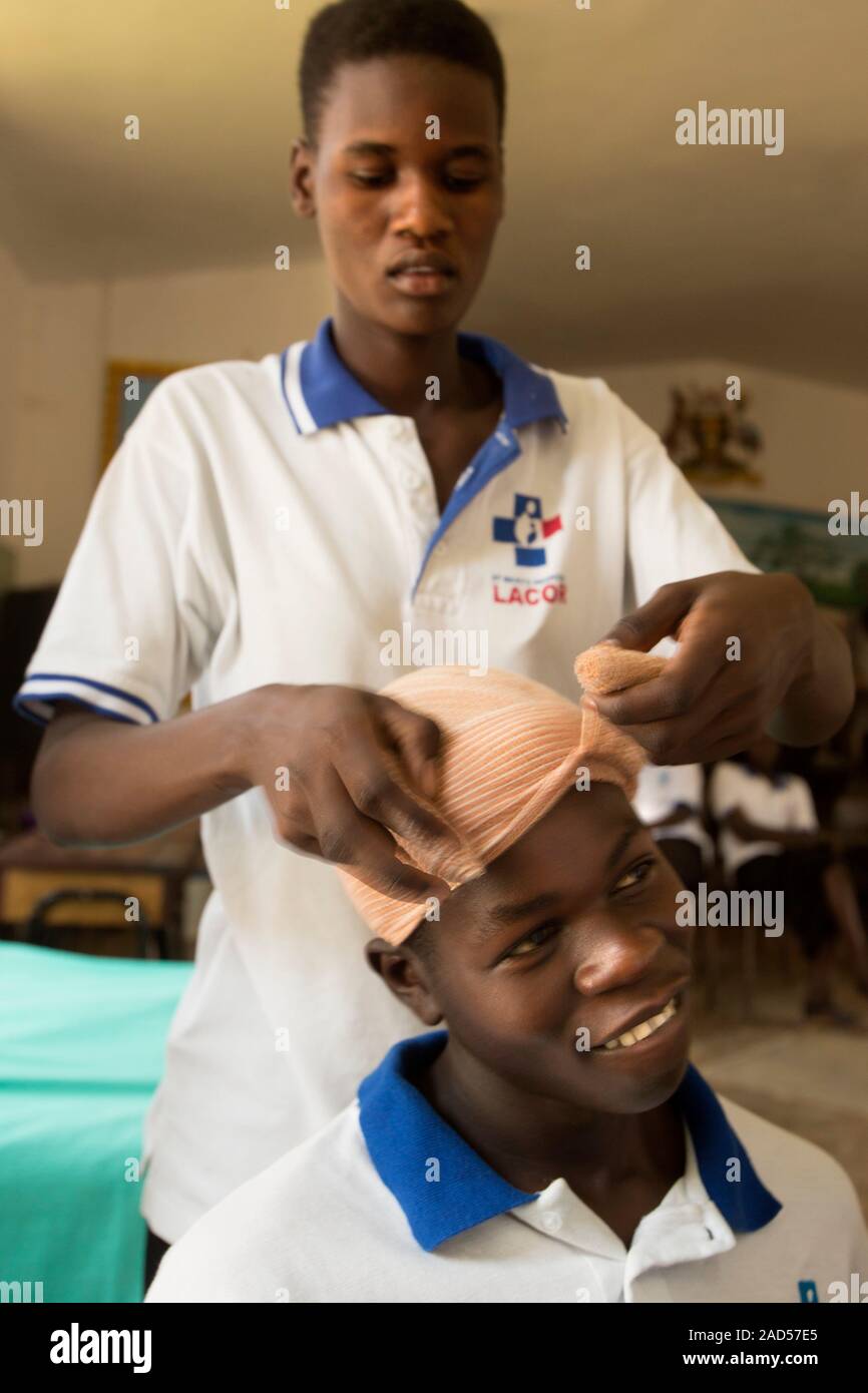 Bandaging head wound, hospital training. Students practising using ...