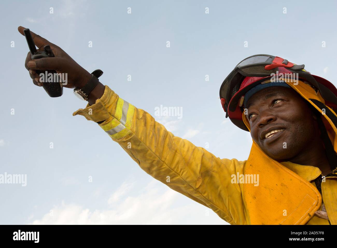 Firefighter pointing while holding a radio. Photographed in Lacor, Gulu ...