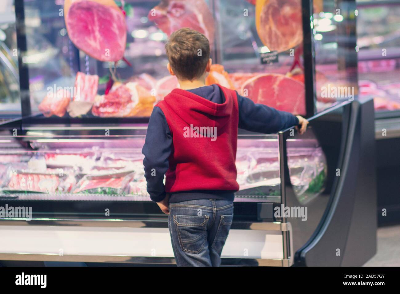 Boy at the counter of a butcher's shop. People Stock Photo - Alamy