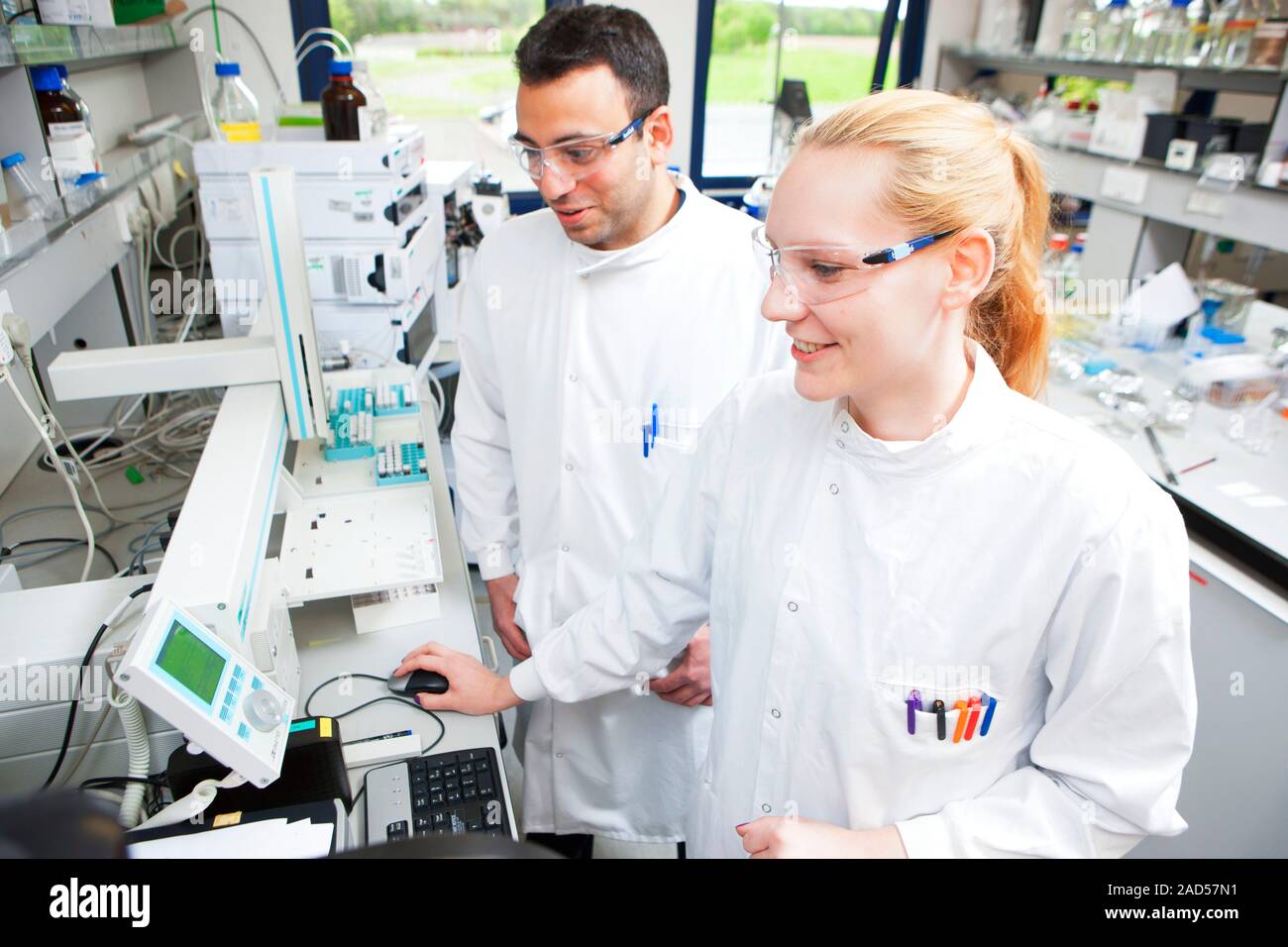 Protein analysis. Researchers carrying out protein analysis in a ...