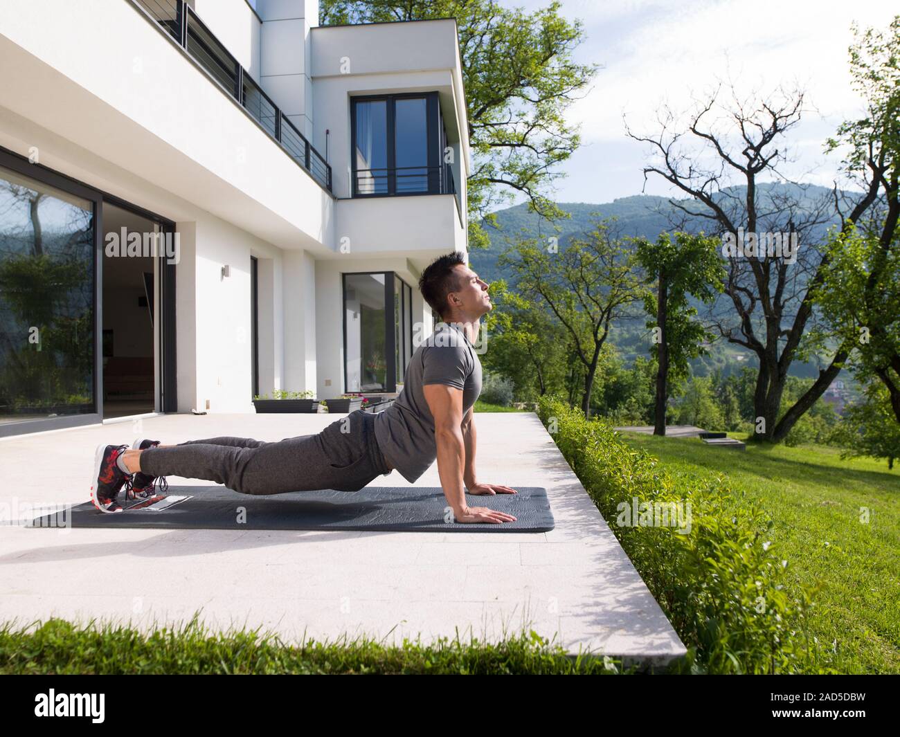 man doing morning yoga exercises Stock Photo - Alamy