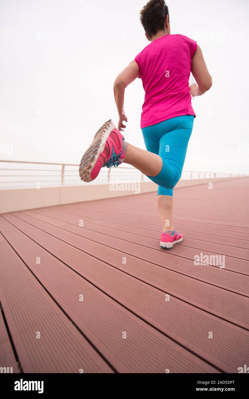 woman busy running on the promenade Stock Photo - Alamy
