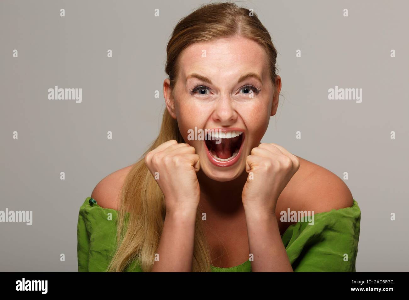 Screaming girl in green dress Stock Photo - Alamy