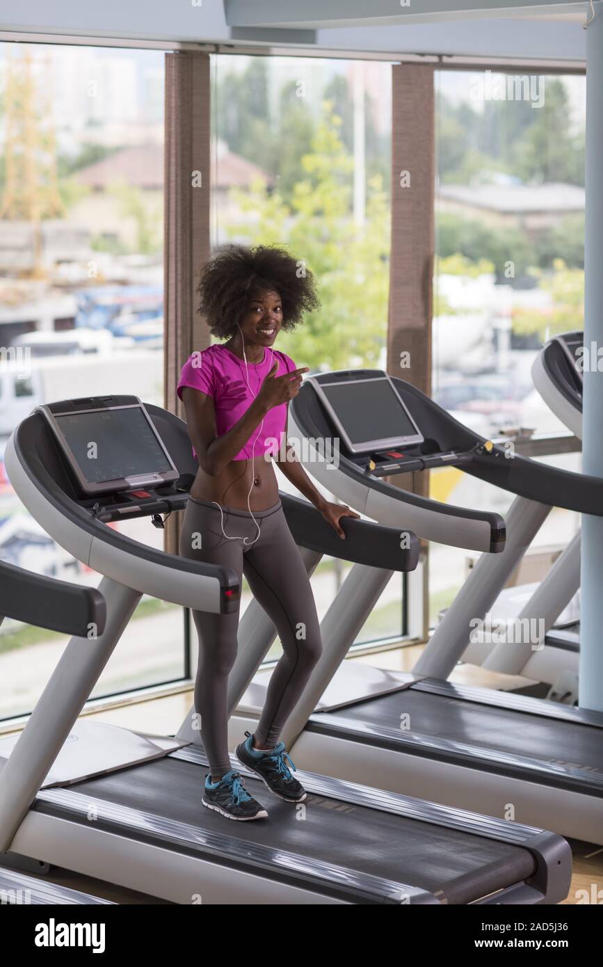 afro american woman running on a treadmill Stock Photo - Alamy