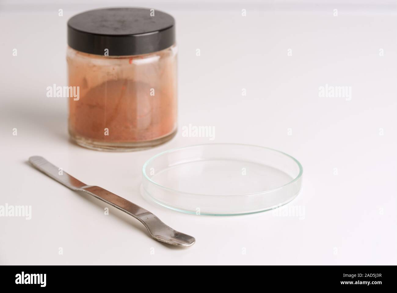 Petri dish and spatula isolated on white background with a pot of iron ...