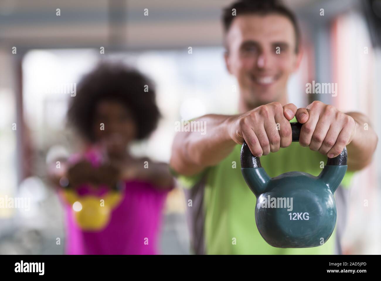 couple workout with weights at crossfit gym Stock Photo - Alamy
