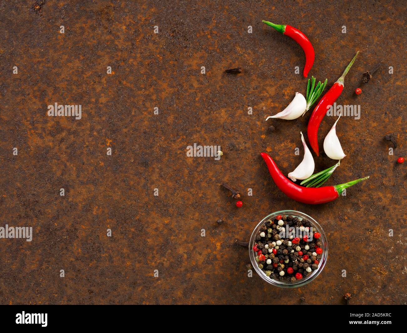 red hot chili pepper pods and peas, garlic clove on dark rusty metal ...