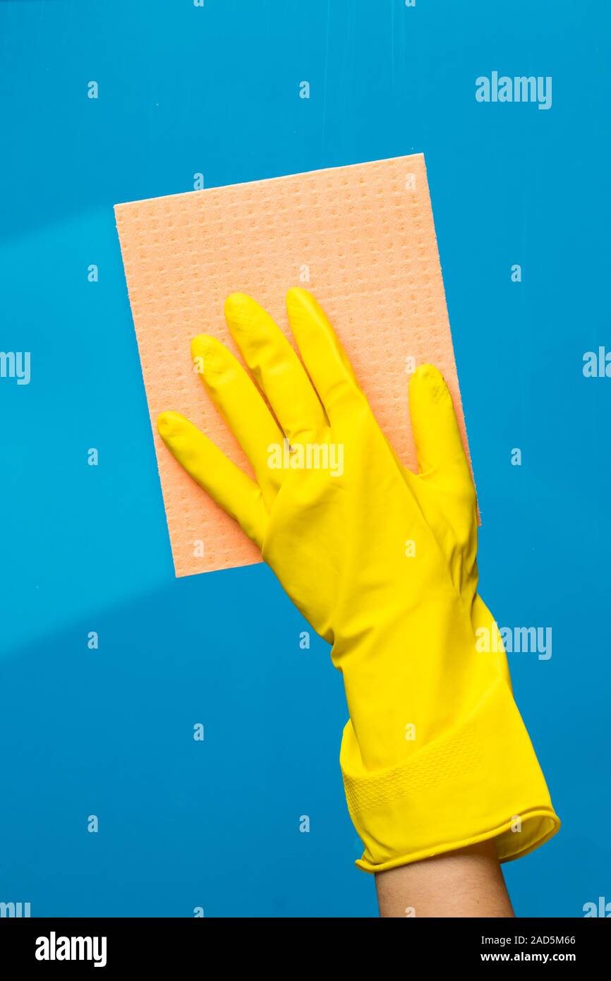 Hand in glove with rag Stock Photo - Alamy