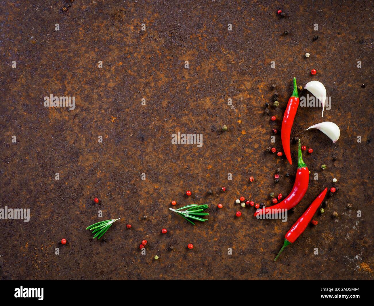 red hot chili pepper pods and peas, garlic clove on dark rusty metal ...