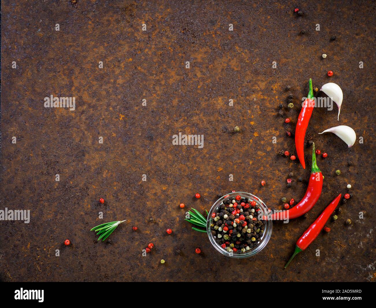 red hot chili pepper pods and peas, garlic clove on dark rusty metal ...