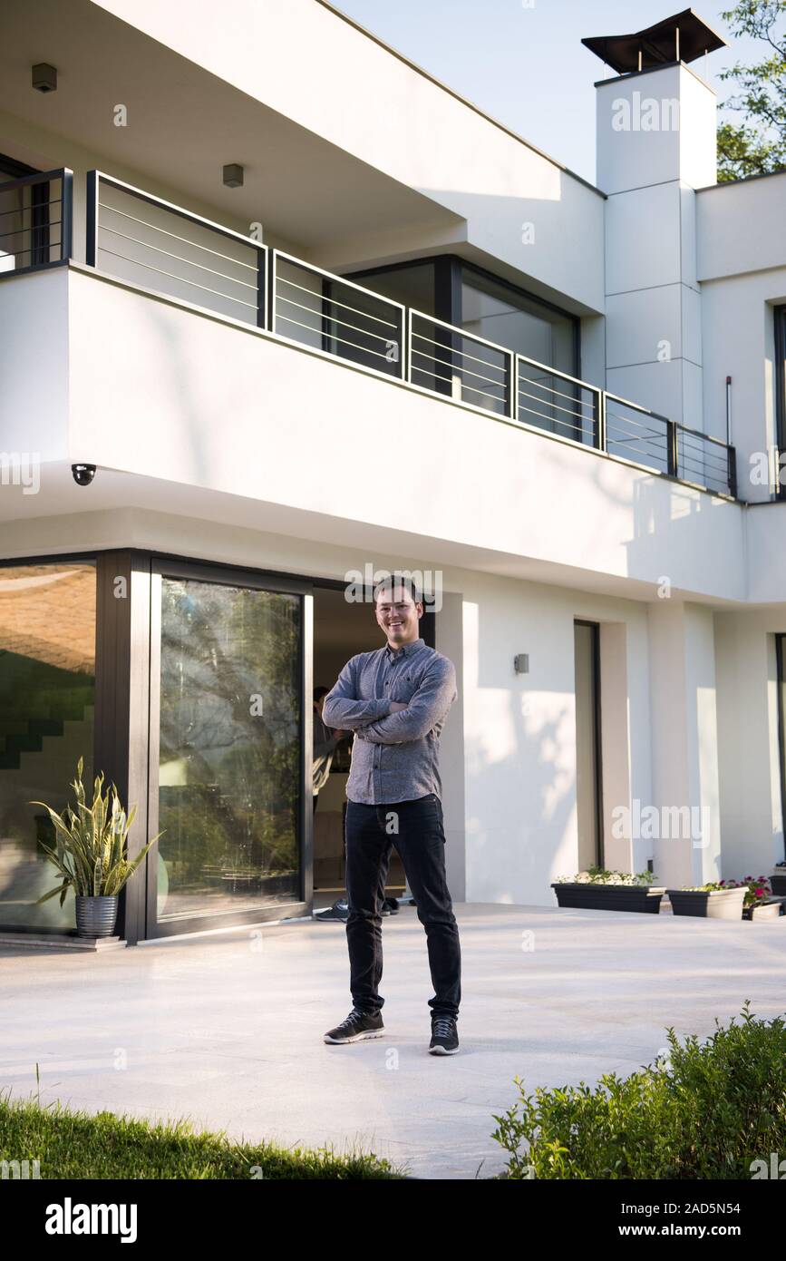 man in front of his luxury home villa Stock Photo - Alamy