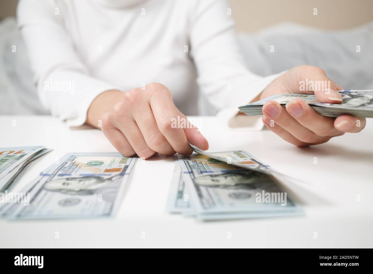 Close up of woman with calculator counting money Stock Photo - Alamy
