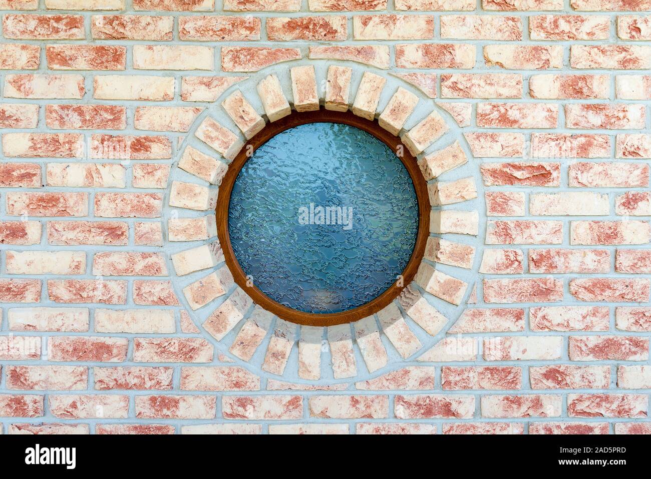 Round window on brick wall Stock Photo - Alamy