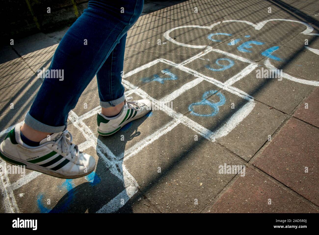 Playground games. Child playing hopscotch in a school playground Stock ...