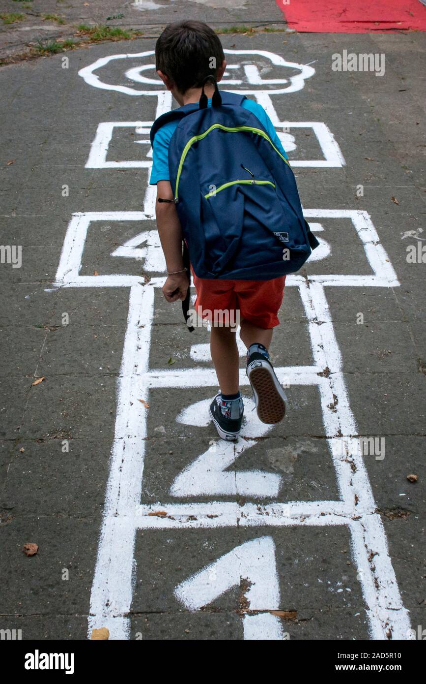 Playground games. Child playing hopscotch in a school playground Stock ...