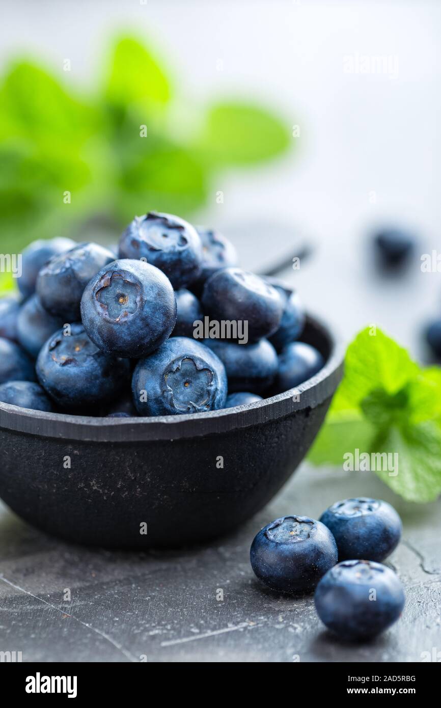 Fresh Blueberries in a bowl on dark background, top view. Juicy wild ...