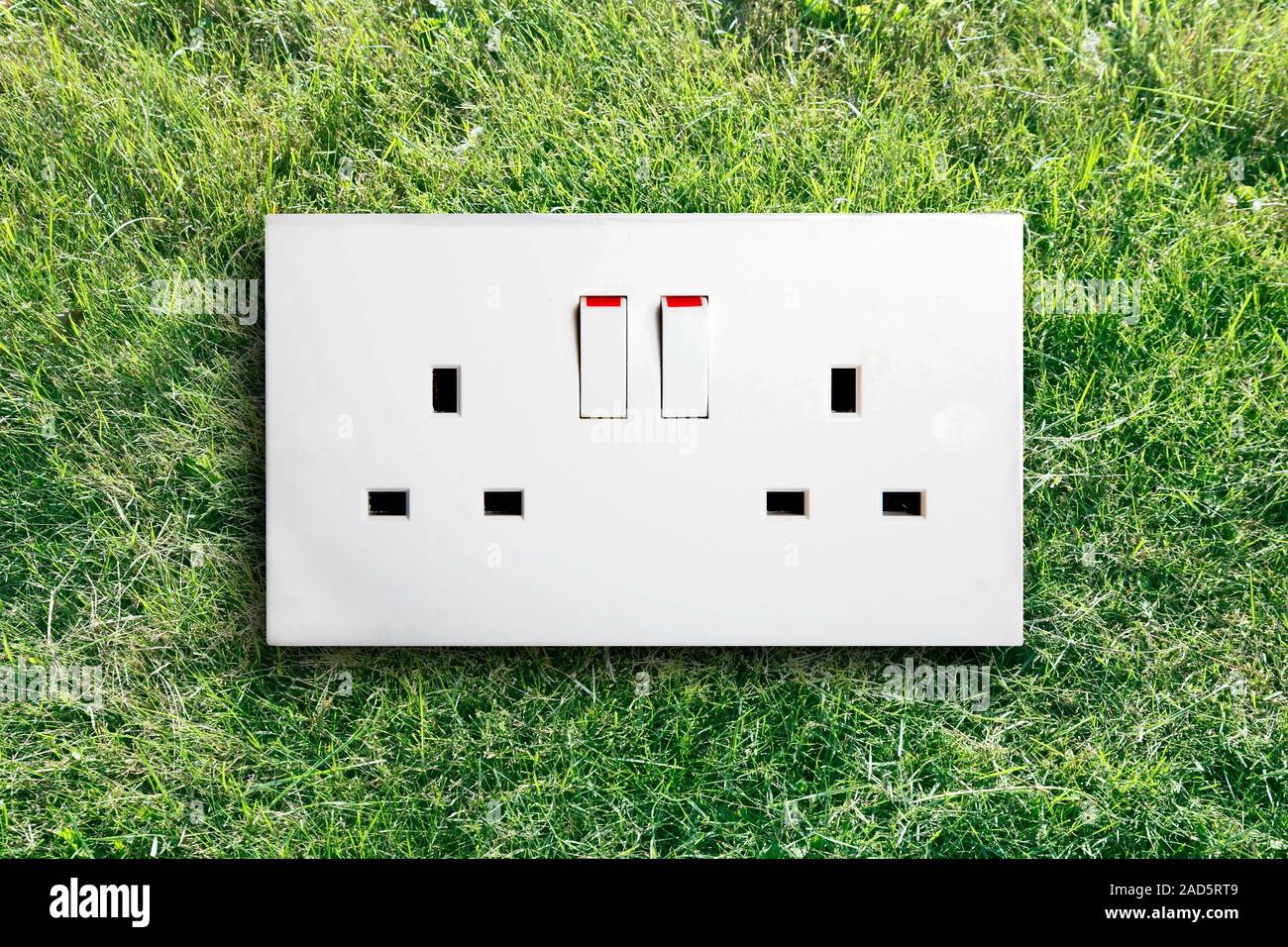 Green energy. Conceptual image of electrical power sockets on grass ...