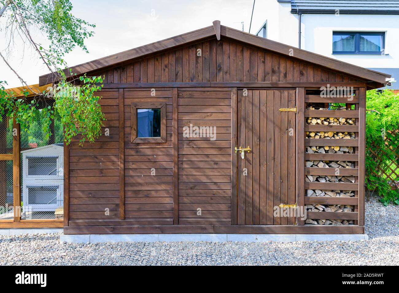 Garden shed exterior in Spring, with woodshed Stock Photo - Alamy