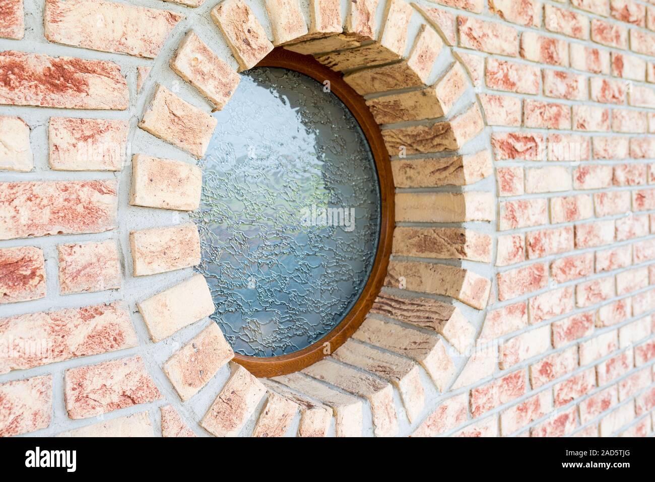 Round window on brick wall - shallow depth of field - focus on the ...