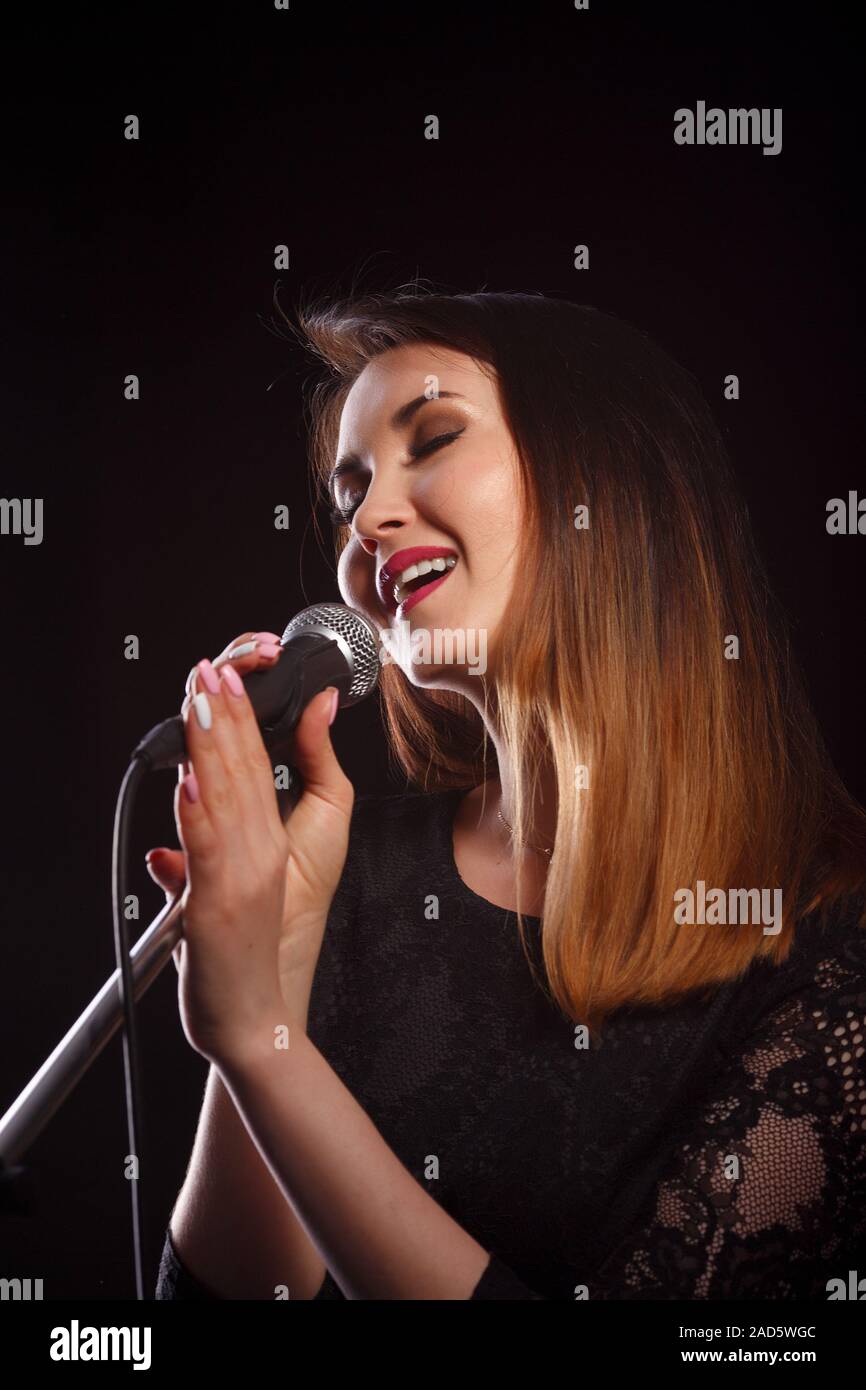 Woman holding microphone closeup hand hi-res stock photography and ...