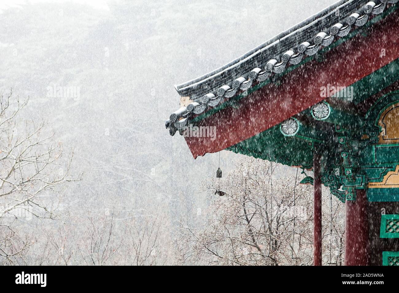 Landscape in winter with roof of temple falling snow in korea Stock ...