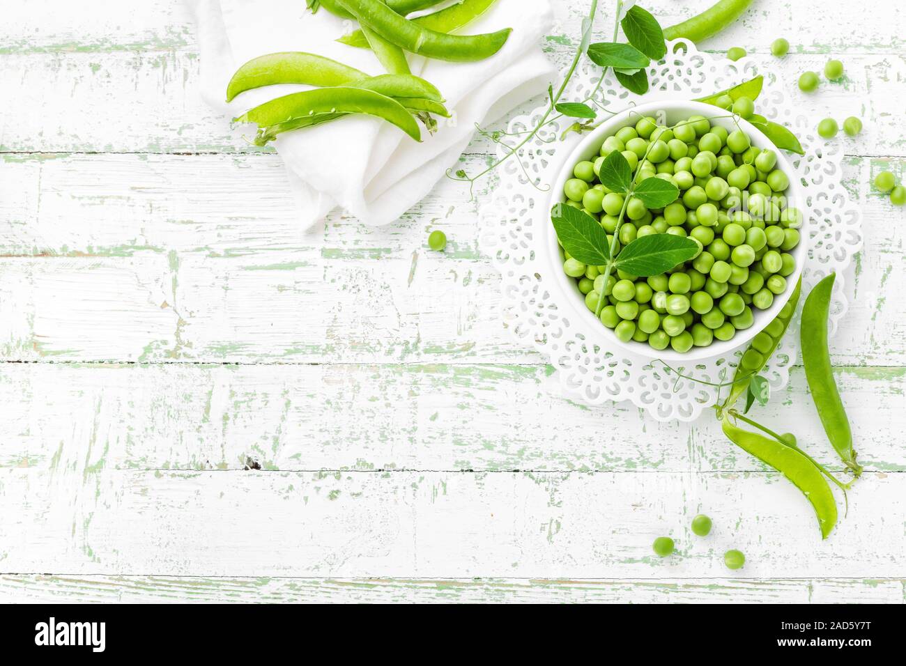 Green peas with leaves on white background Stock Photo - Alamy