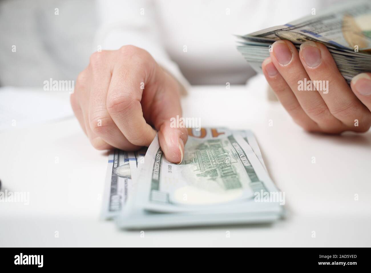 Close up of woman with calculator counting money Stock Photo - Alamy