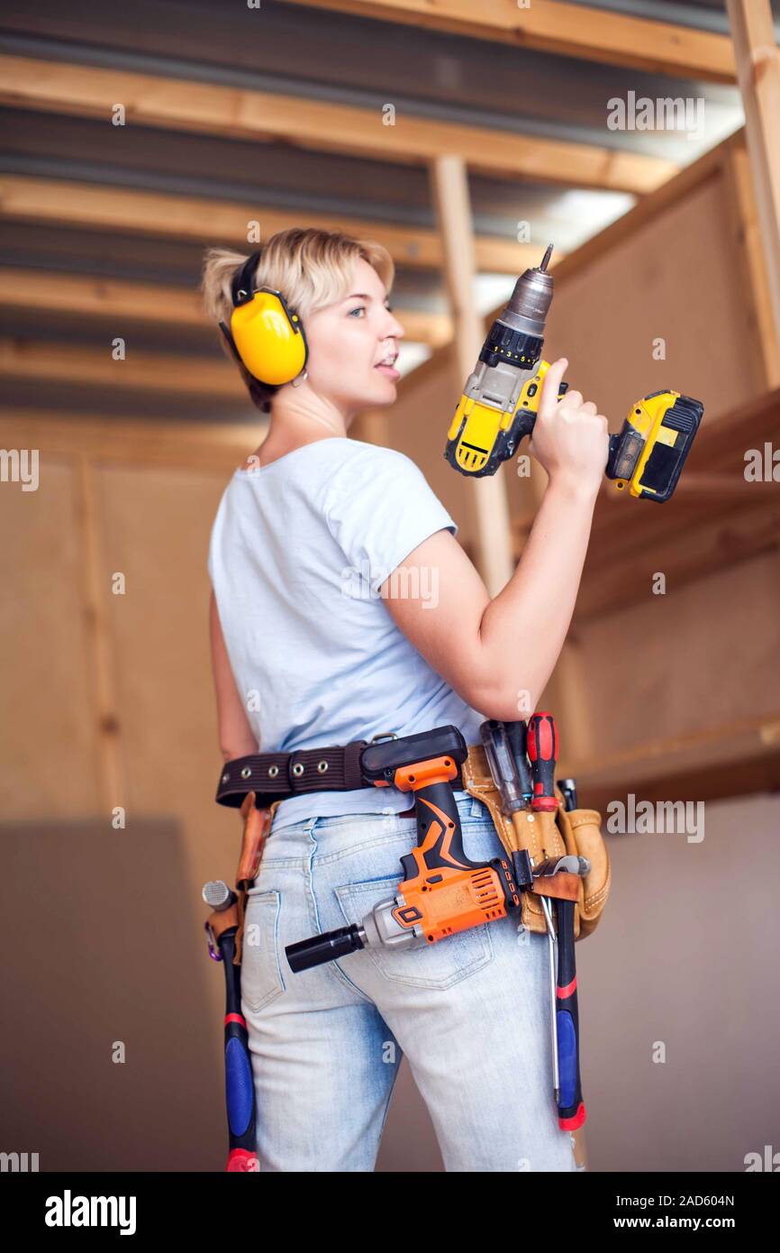 Woman construction worker tool belt hi-res stock photography and images ...