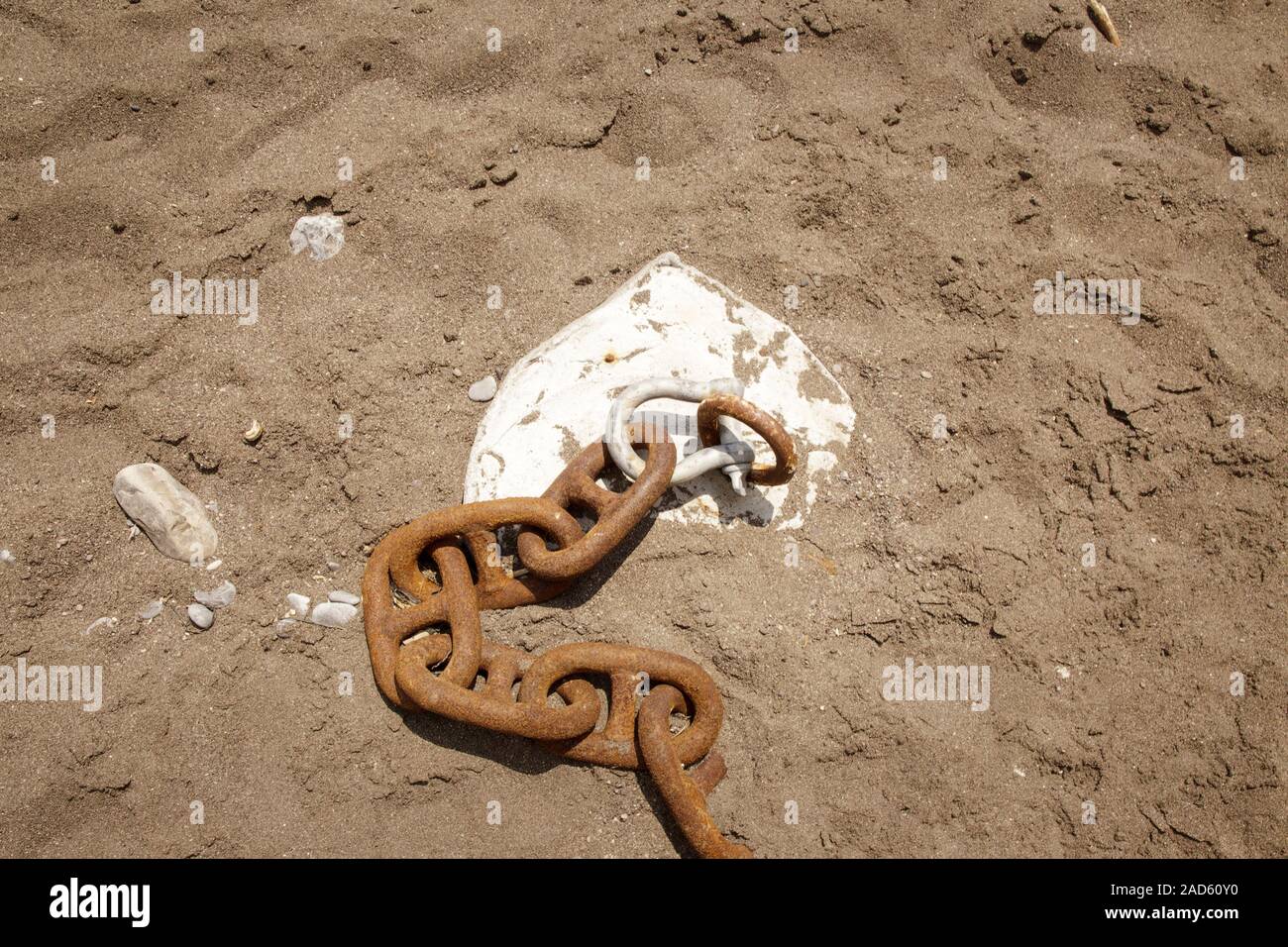 large chain anchor point buried into the beach Stock Photo - Alamy