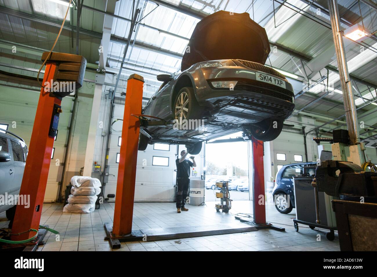 Car servicing. Car being serviced in a garage Stock Photo - Alamy