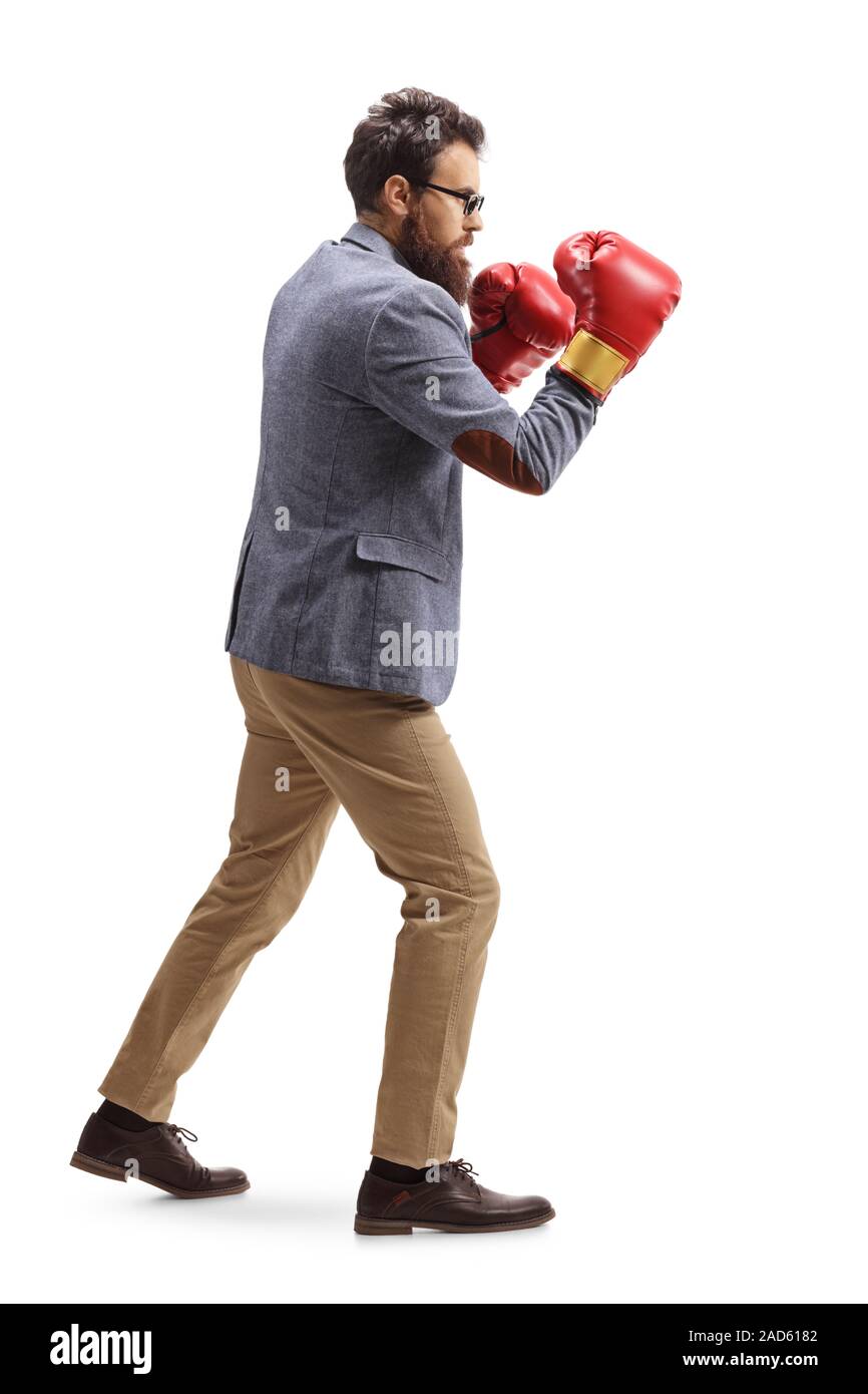Full length profile shot of a casual man boxing with boxing gloves ...