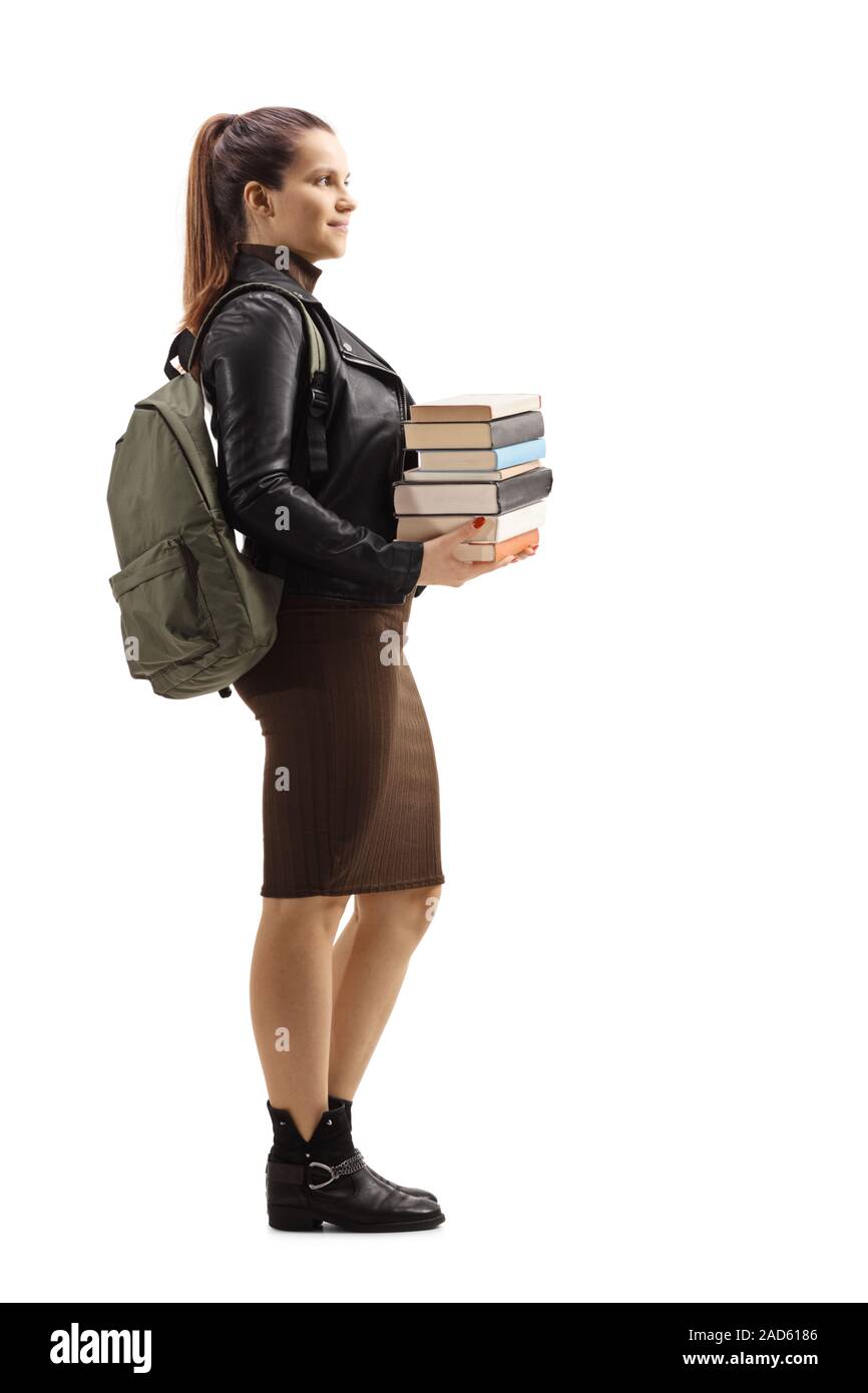 Full length profile shot of a trendy female student holding a pile of ...