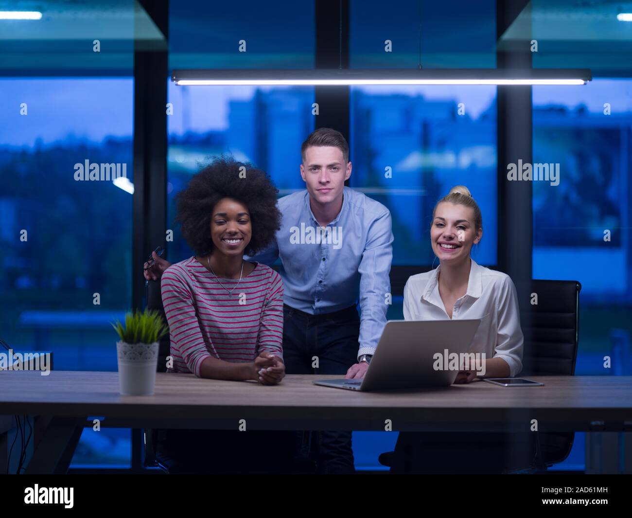 Multiethnic startup Business team in night office Stock Photo - Alamy
