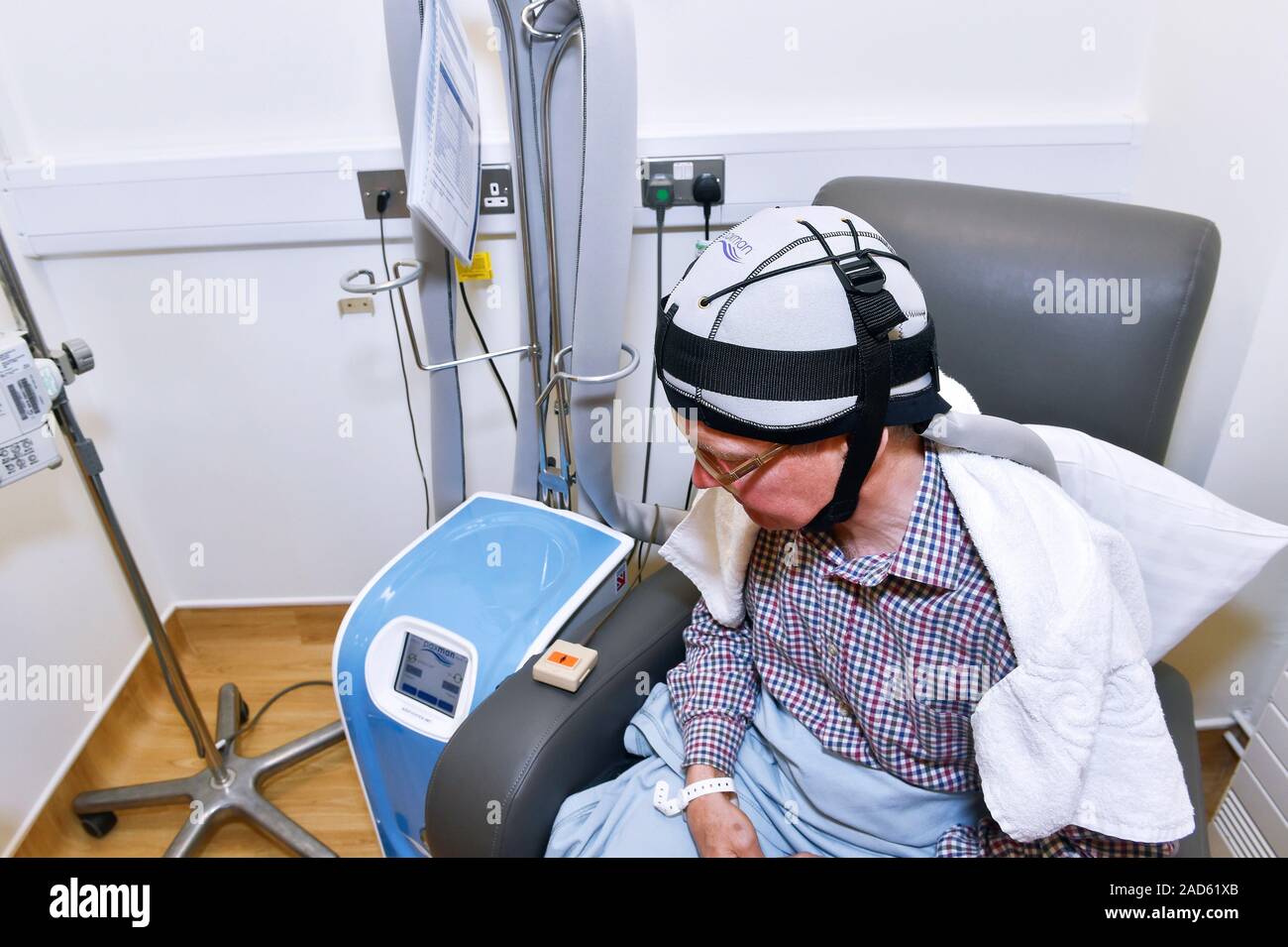 Prostate cancer chemotherapy. Cooling cap being worn by a 65-year-old ...
