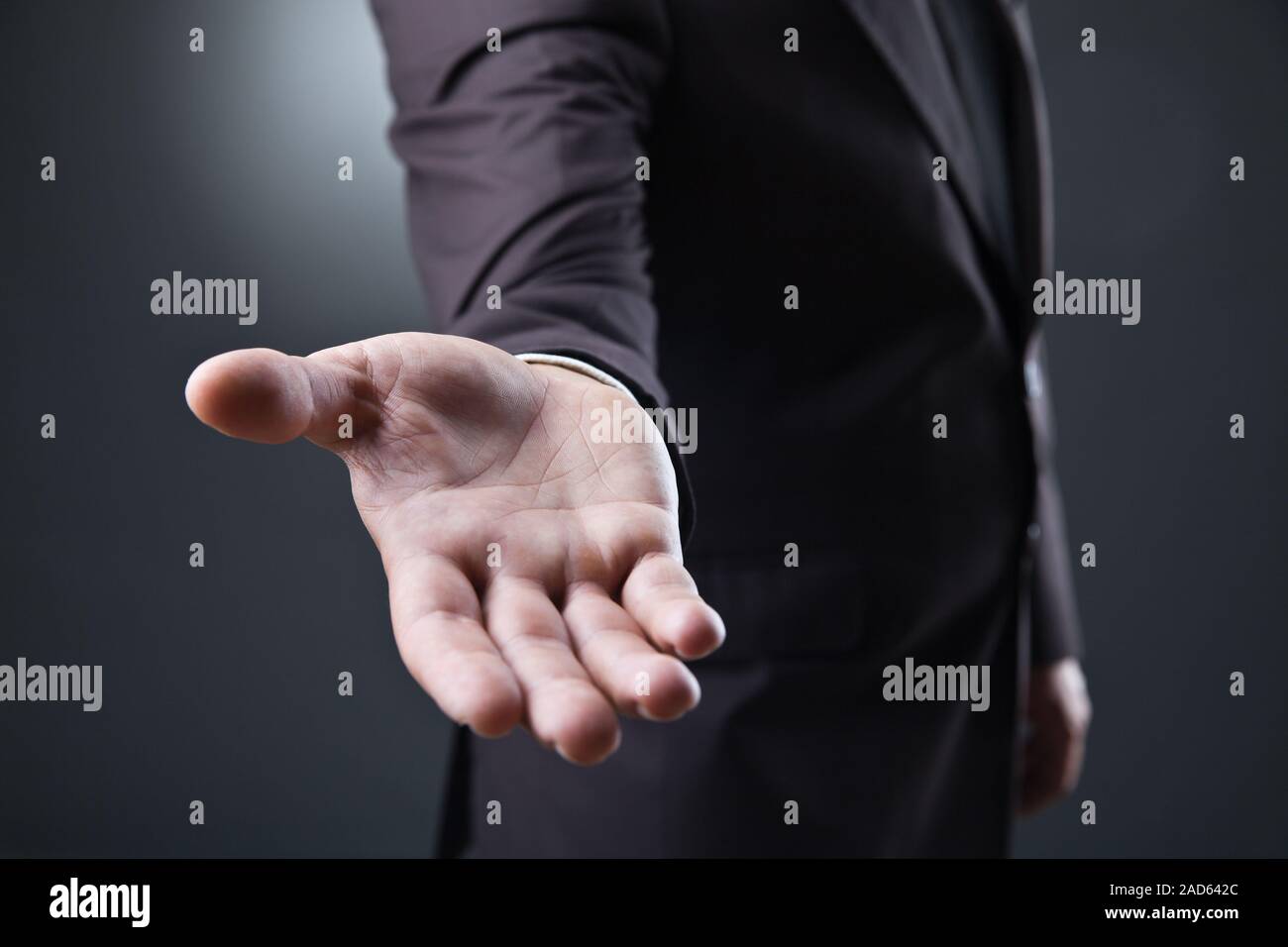 Business man with empty hand on dark Stock Photo - Alamy