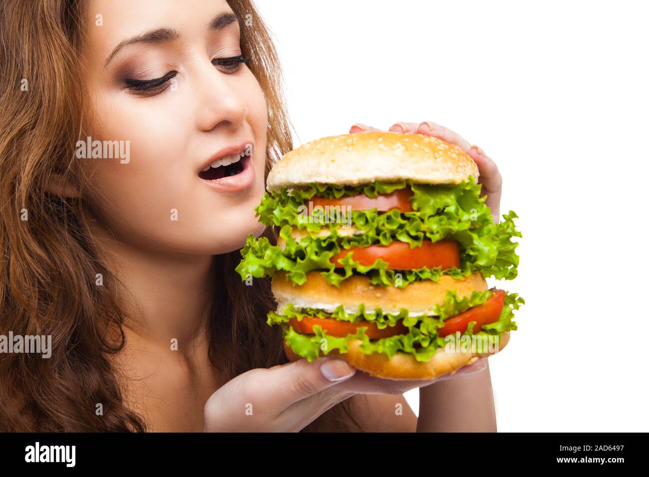 Happy Young Woman Eating big yummy Burger isolated Stock Photo - Alamy