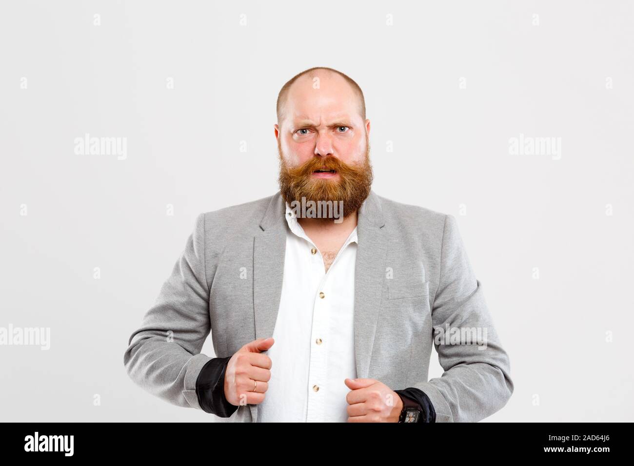 Embarrassed man in gray jacket Stock Photo - Alamy