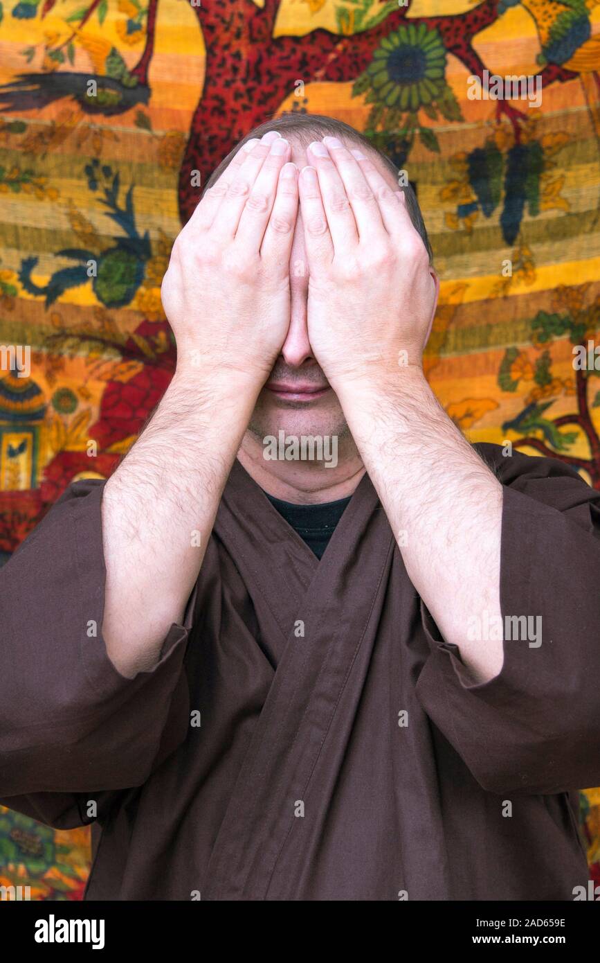 Reiki self-treatment. Man performing Reiki on himself. Reiki is a form ...