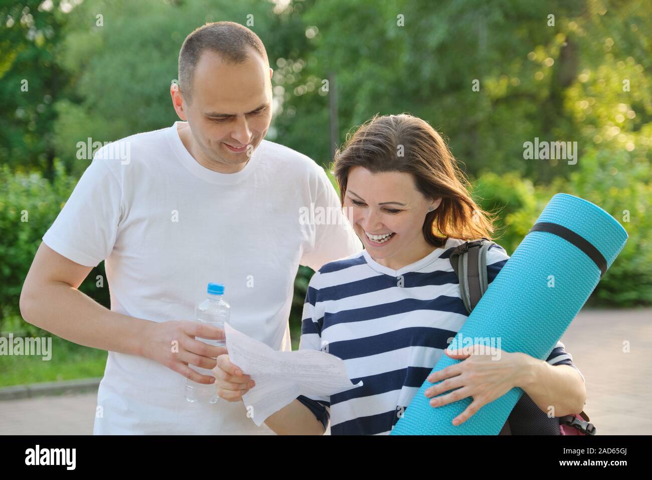 Mature couple reading paper document letter outdoor Stock Photo - Alamy