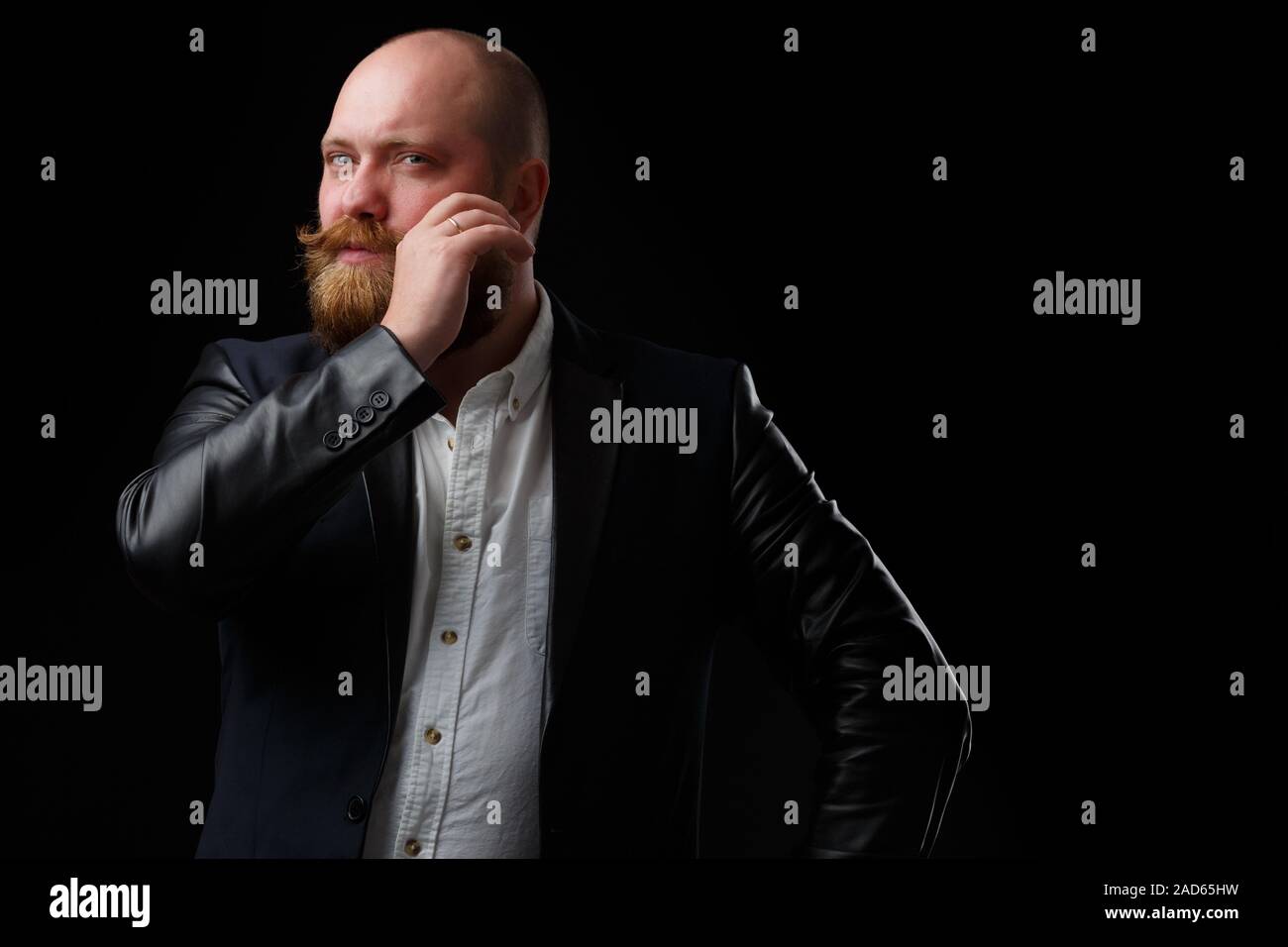 Man curls his ginger mustache Stock Photo - Alamy