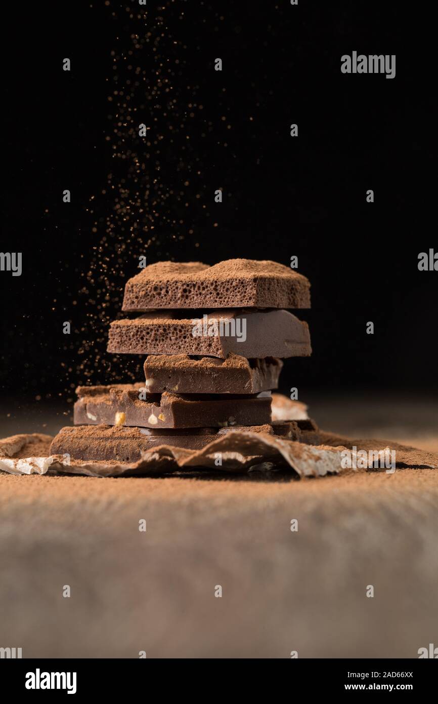 Broken chocolate on bakery paper Stock Photo - Alamy