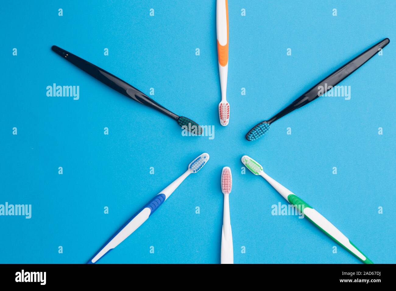 Multi-colored toothbrushes arranged in circle Stock Photo - Alamy