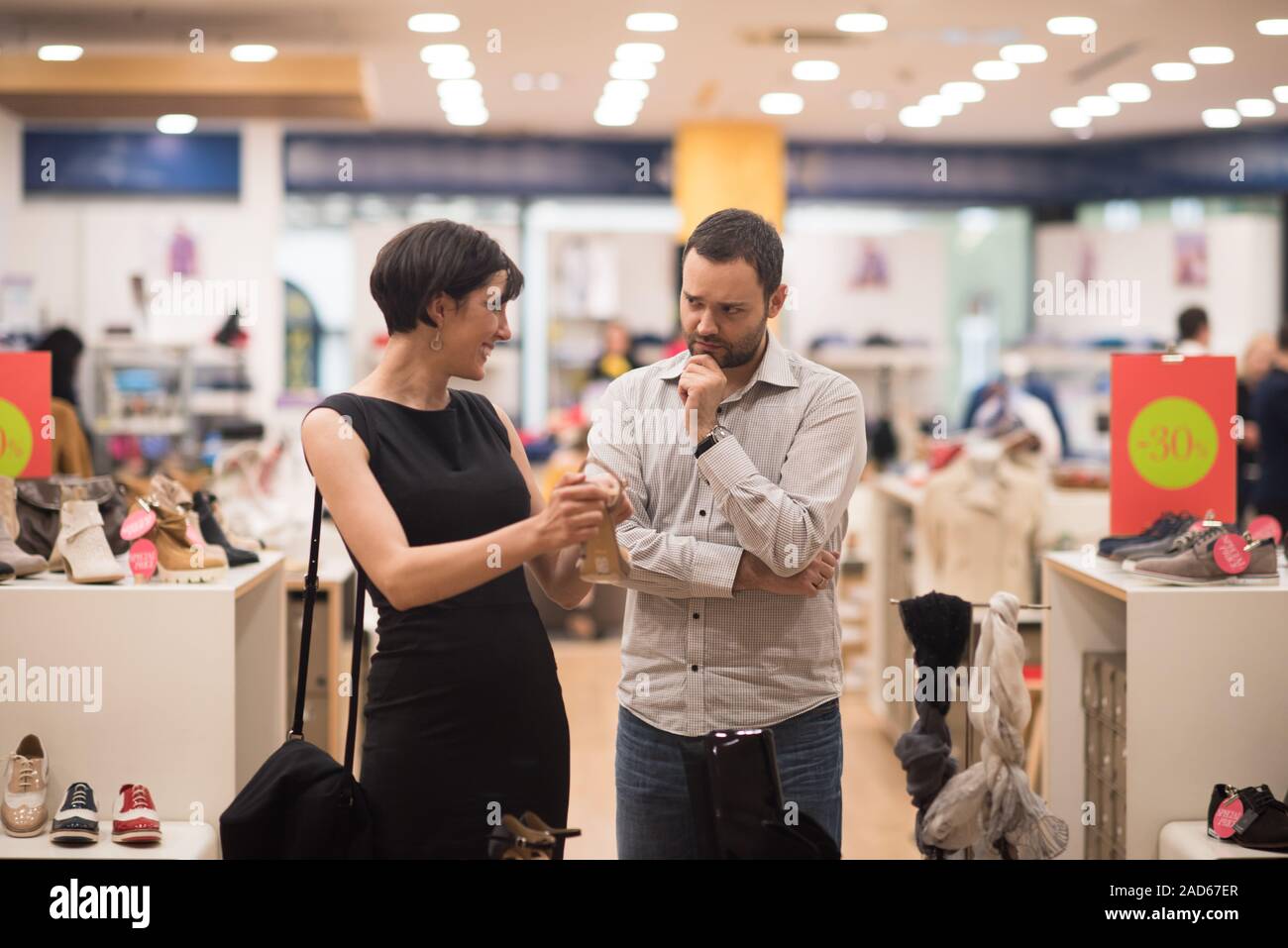 Woman choosing boots at shoe store hi-res stock photography and images ...
