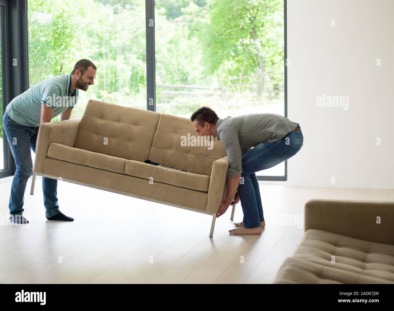 Two men carrying sofa hi-res stock photography and images - Alamy
