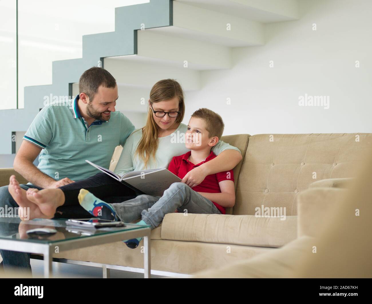 family with little boy enjoys in the modern living room Stock Photo - Alamy