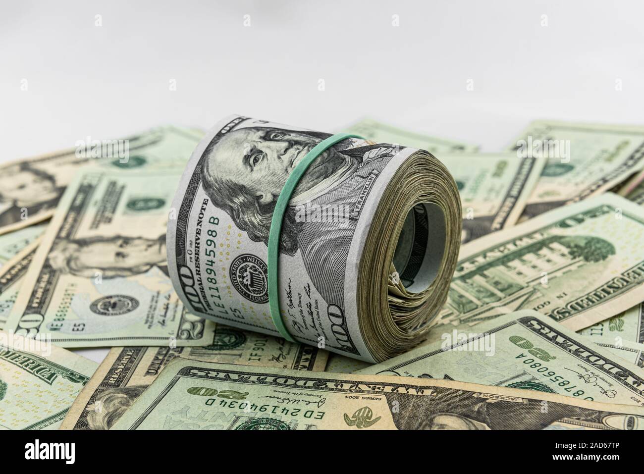 Roll of US Currency, a Bankroll, on a blanket of paper money Stock ...