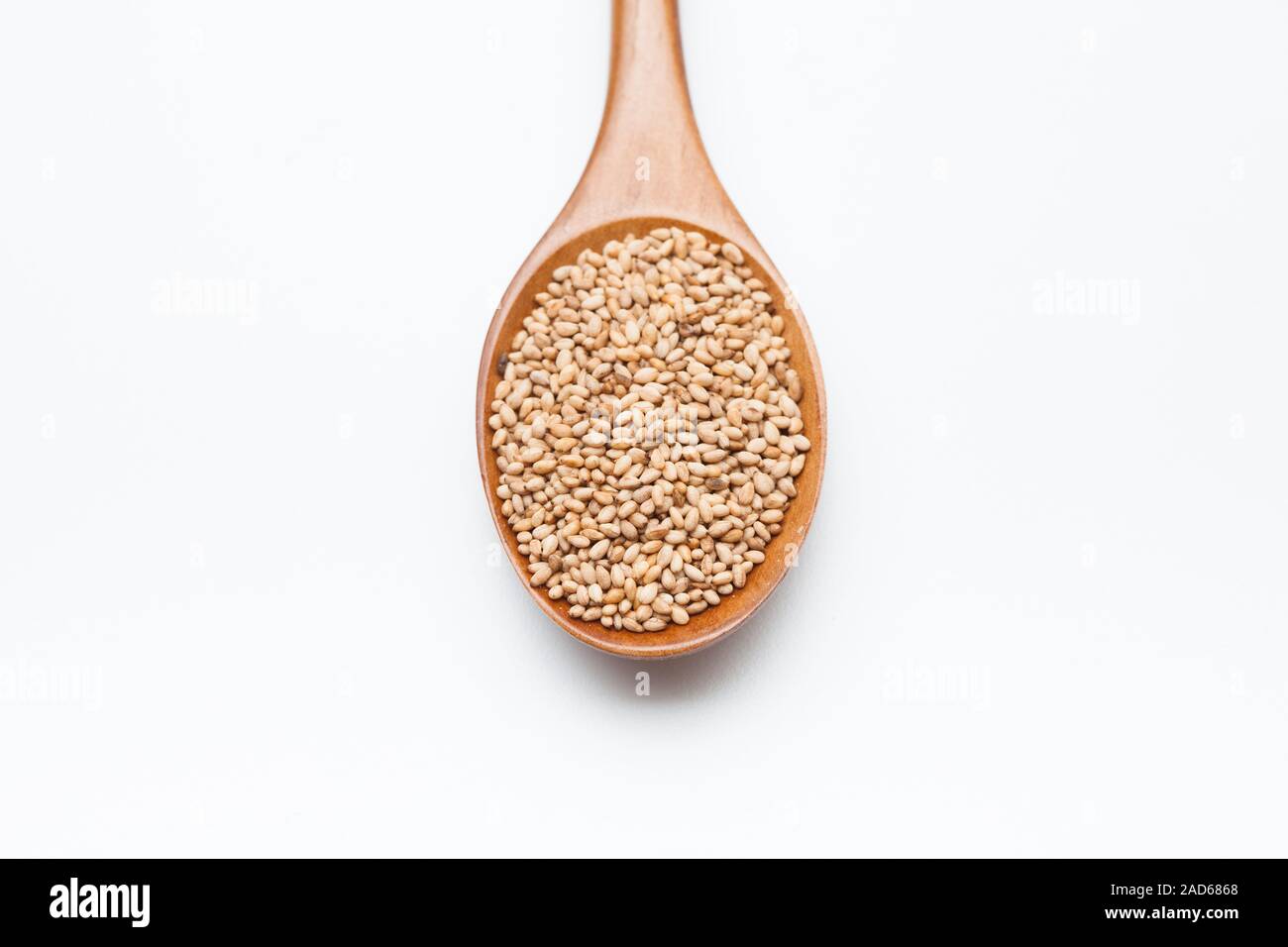 Toasted Sesame seeds in wooden spoon on white Stock Photo - Alamy